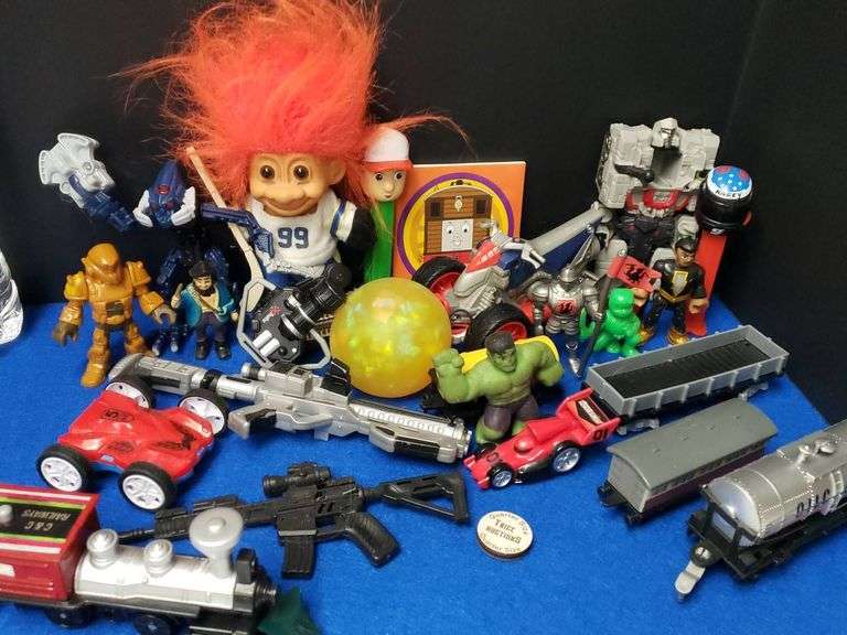 Assorted Lot of Action Figures, Toy Vehicles, Troll Doll, and Train Set ...