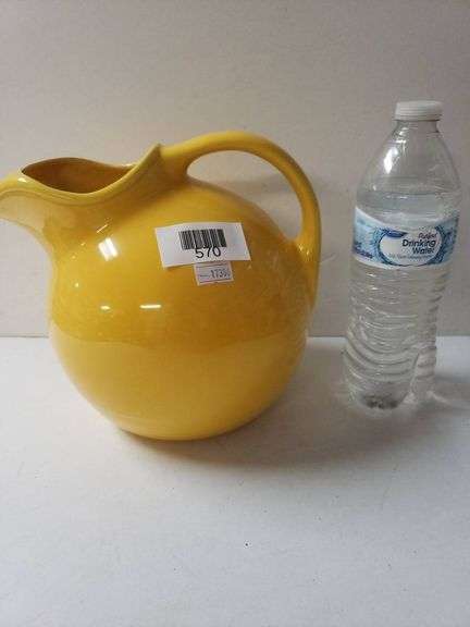 Yellow Ceramic Pitcher with Round Body and Curved Handle - Trice Auctions