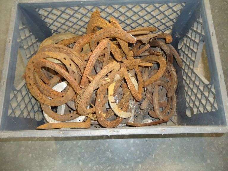 Crate full of rusty horse shoes. - Texas Online Auction House