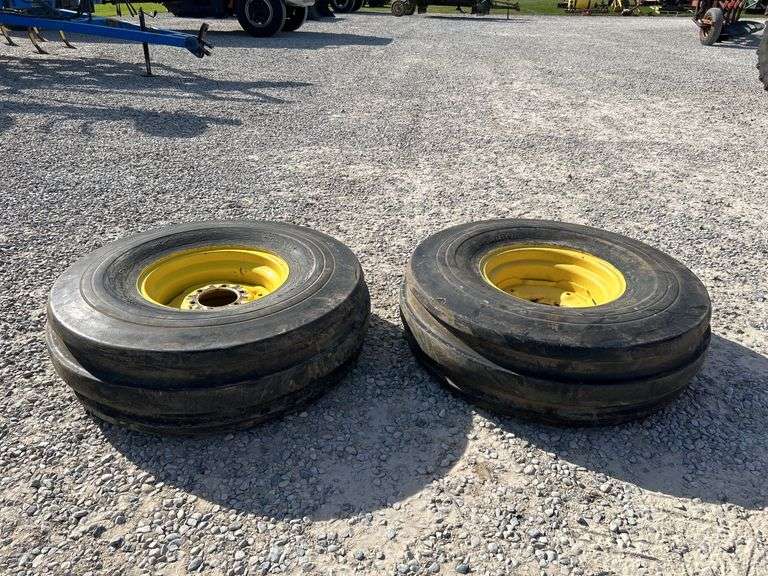 2- 11.00x16 TRI-RIB TIRES WITH 6 BOLT RIMS - Shackelton Auctions Inc.