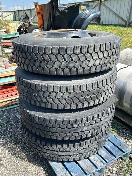 FOUR GENERAL D660 11R22.5 TIRES WITH RIMS - Shackelton Auctions Inc.